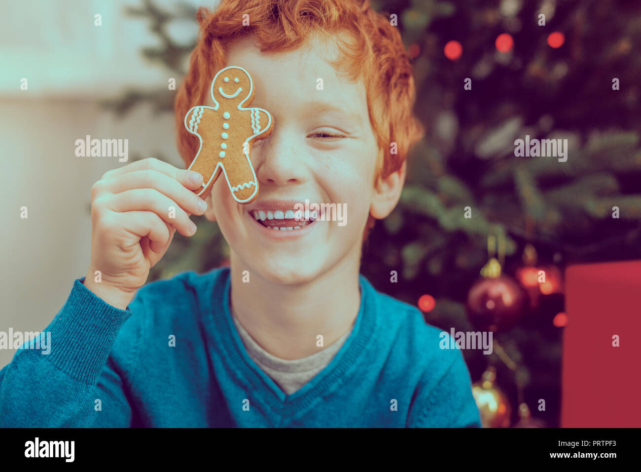 Funny boy playing with biscuit Stock Photo - Alamy
