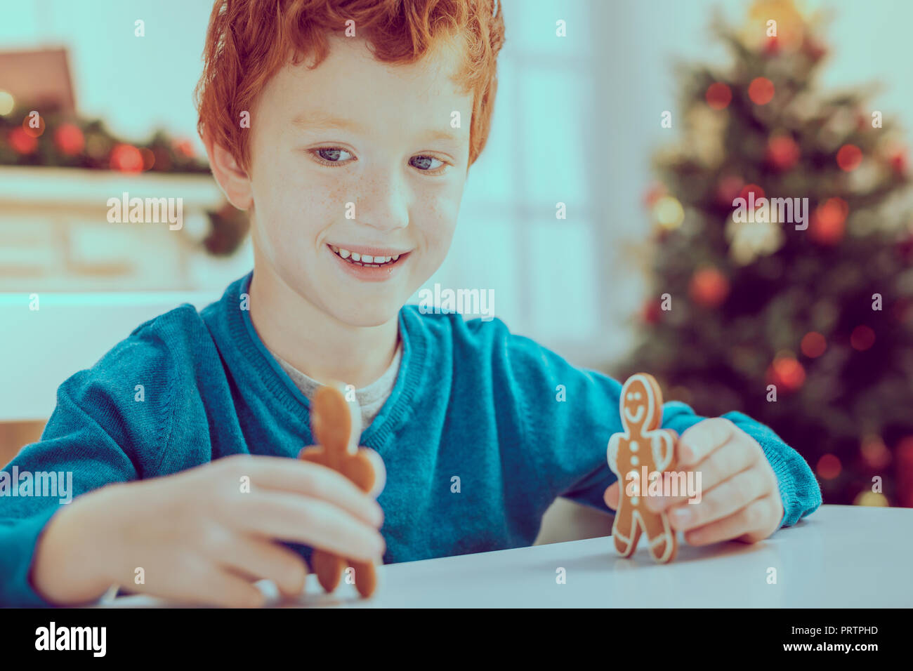 Handsome child playing with gingerbread Man Stock Photo - Alamy