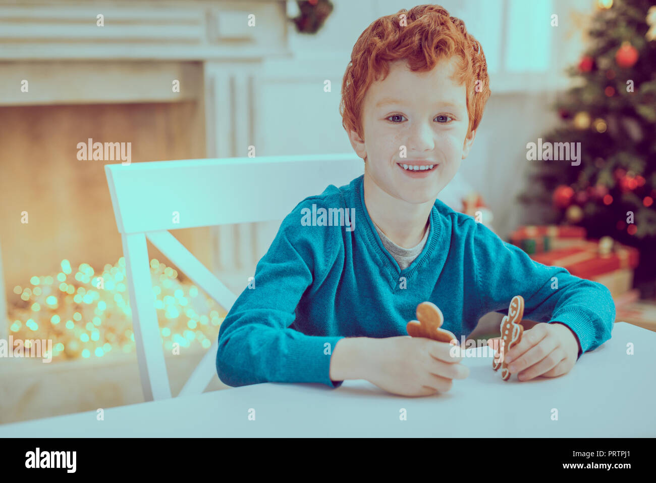 Positive delighted child holding biscuits Stock Photo - Alamy