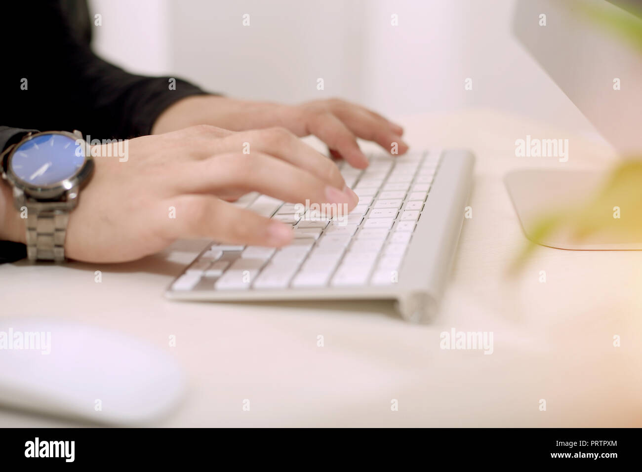 Typing hands on keyboard with mouse Stock Photo - Alamy