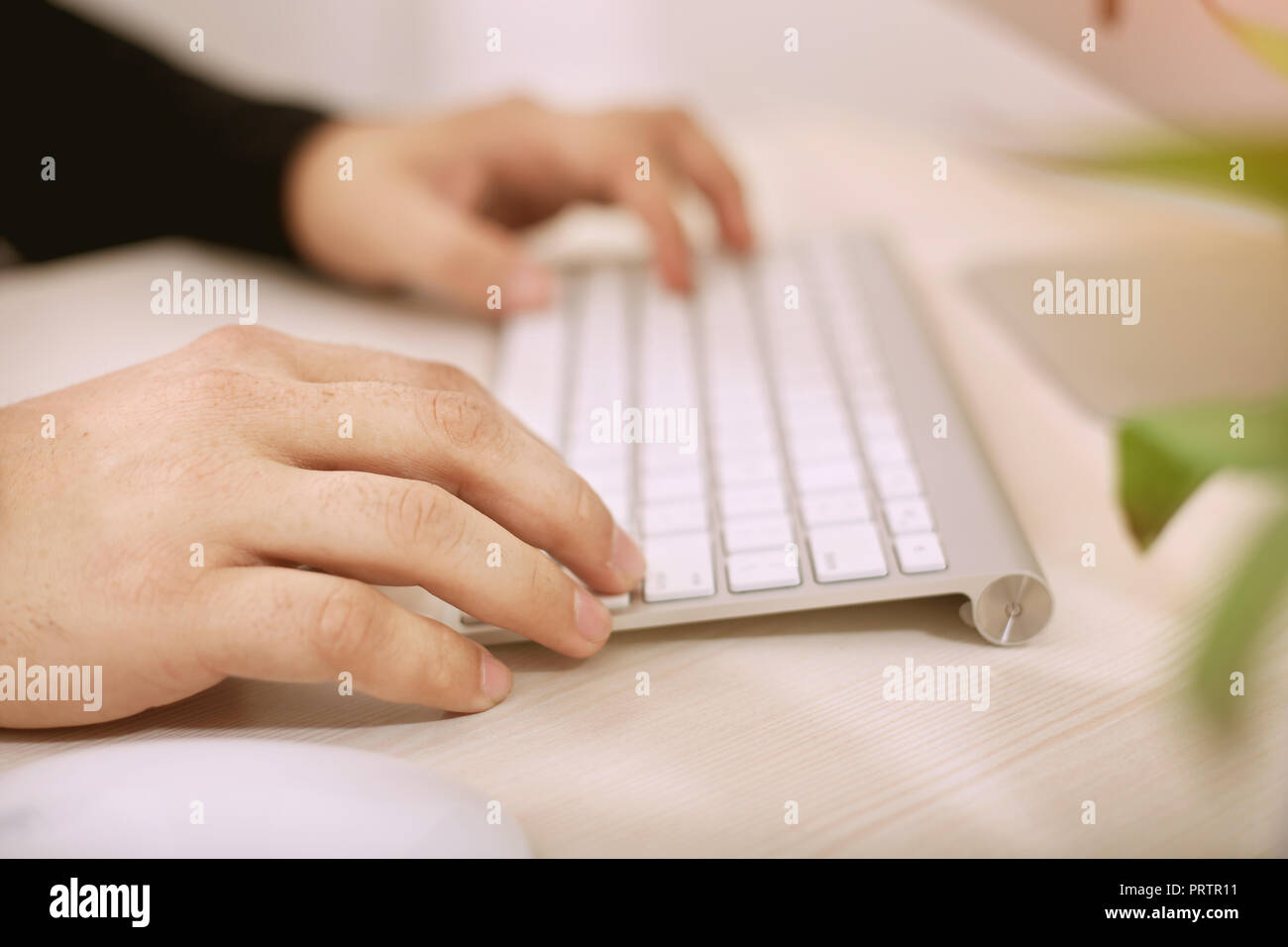 Typing hands on keyboard Stock Photo - Alamy