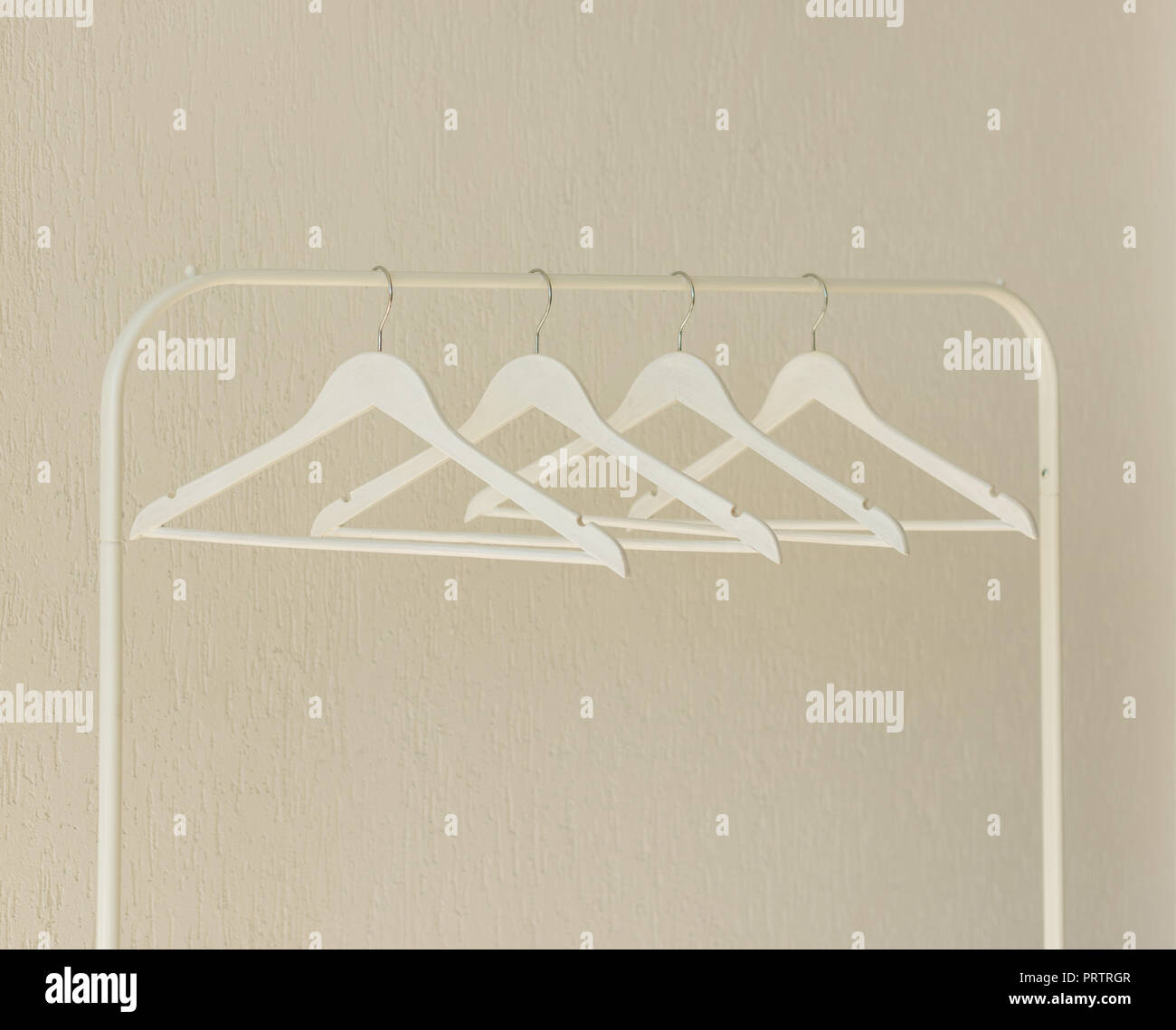 White row of hangers on the rack. Selective focus Stock Photo - Alamy