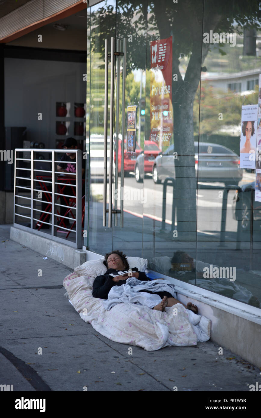 A homeless man sleeping on the sidewalk on Vermont Street in Los ...