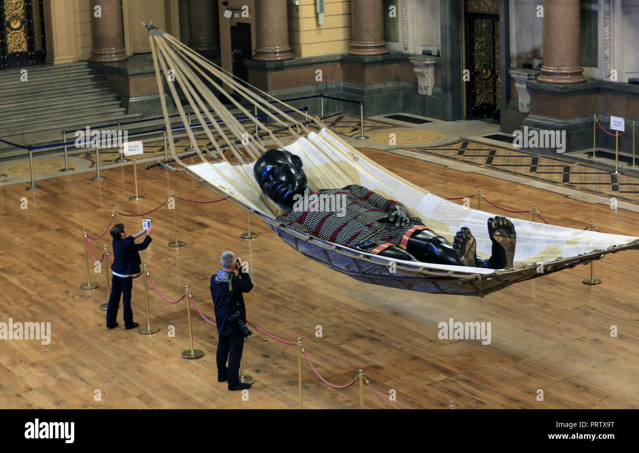 A giant boy figure sleeps in a hammock inside Liverpool's St Georges ...