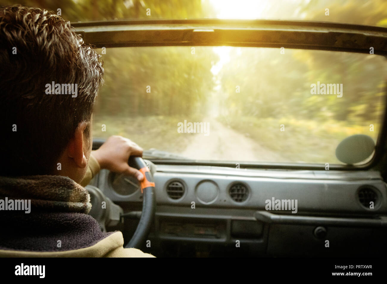 A view from behind the steering wheel of a car. The view from the back ...