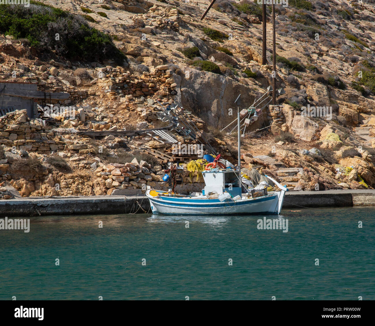 A fishing boat waits in the harbour at Herronissos on the island of ...