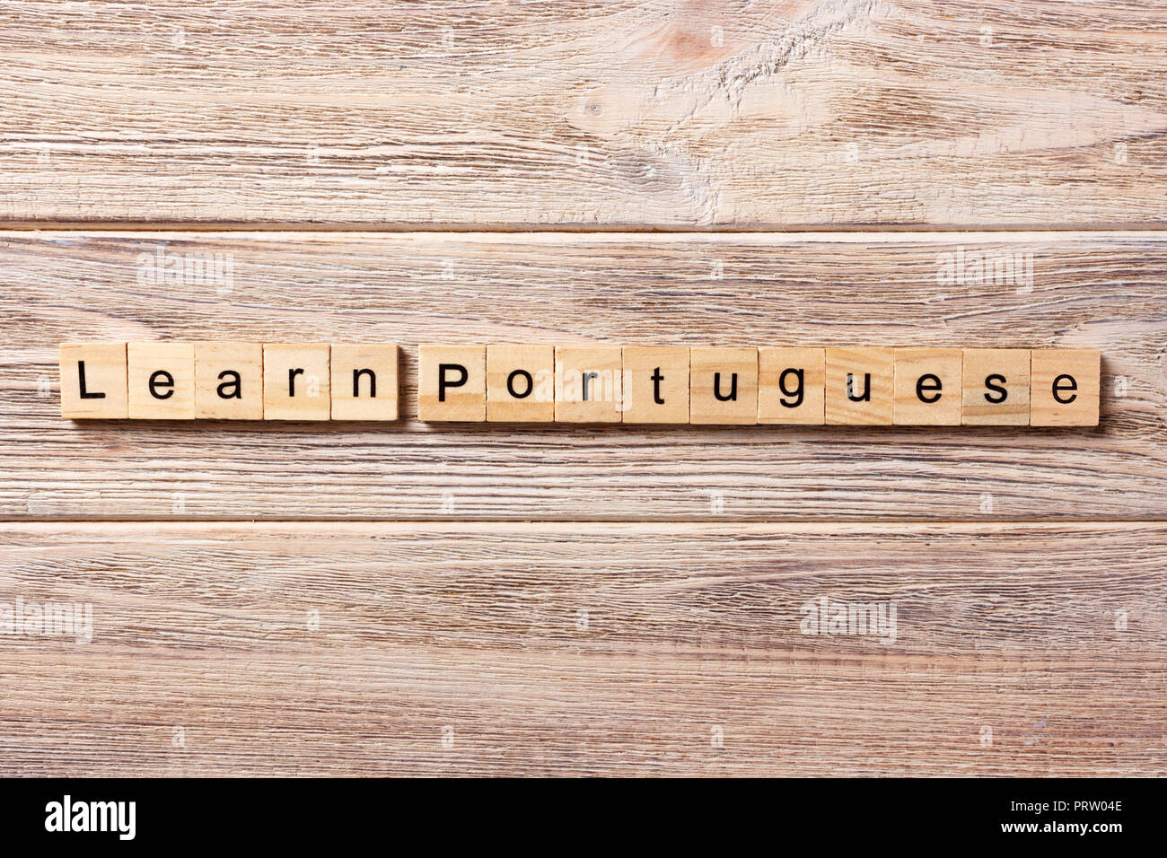 learn portuguese word written on wood block. learn portuguese text on ...