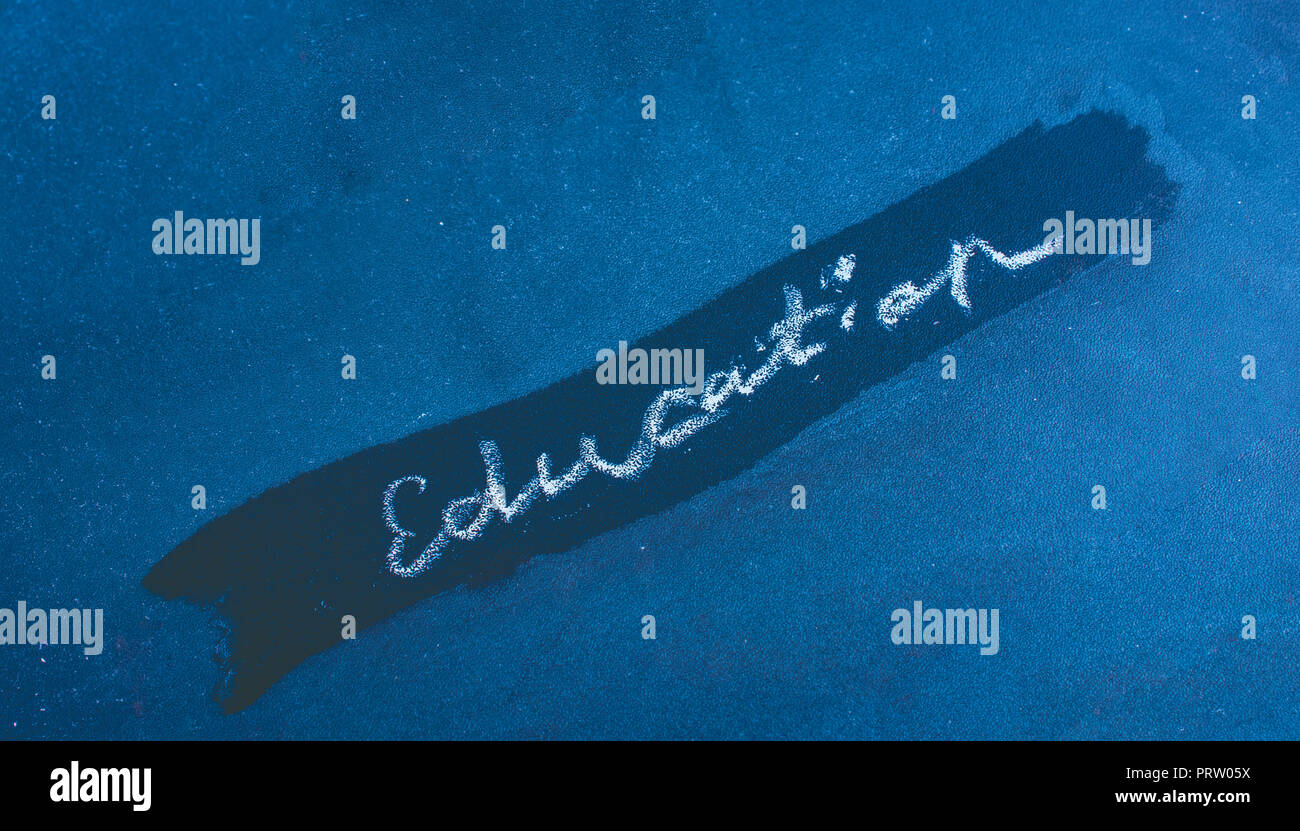 Hand written word EDUCATION with white chalk on black board Stock Photo ...