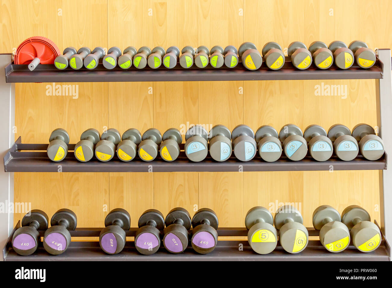 Rows of colored dumbbells in the gym Stock Photo - Alamy