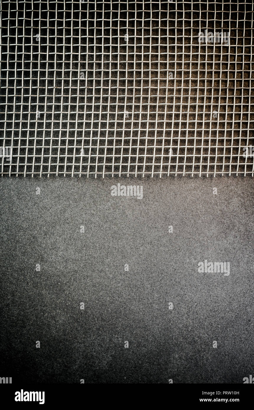 metallic mesh on a dark stone surface - repeating pattern Stock Photo ...