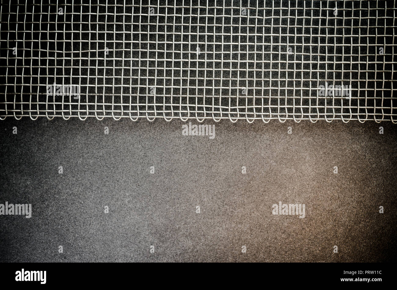 metallic mesh on a dark stone surface - repeating pattern Stock Photo ...