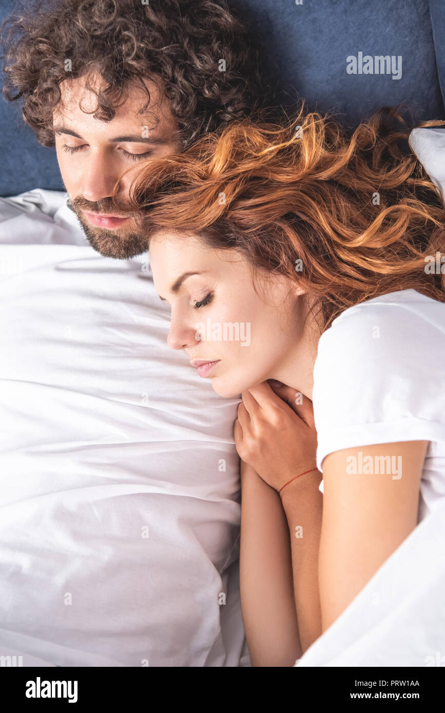 top view of beautiful young couple sleeping together in bed Stock Photo ...