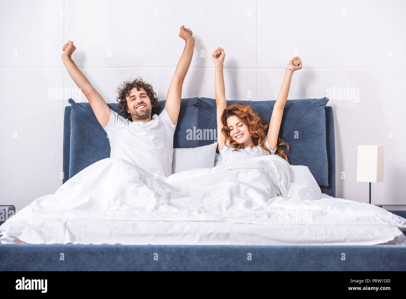 Adult couple waking up in bed hi-res stock photography and images - Alamy