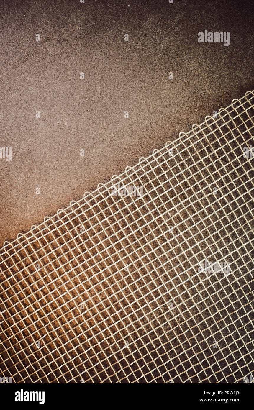metallic mesh on a dark stone surface - repeating pattern Stock Photo ...