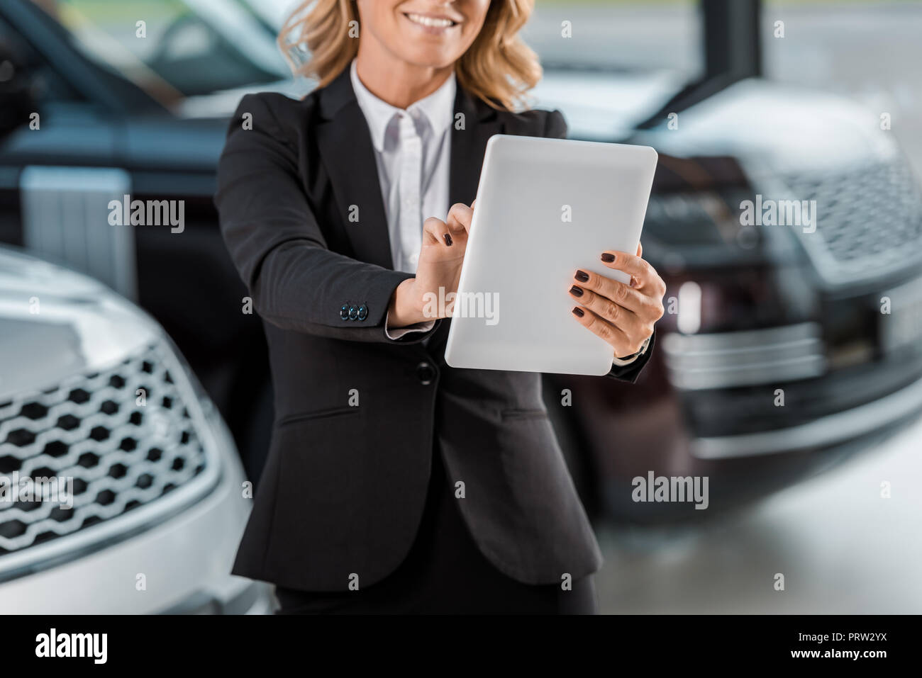 Successful car dealership manager tablet hi-res stock photography and ...