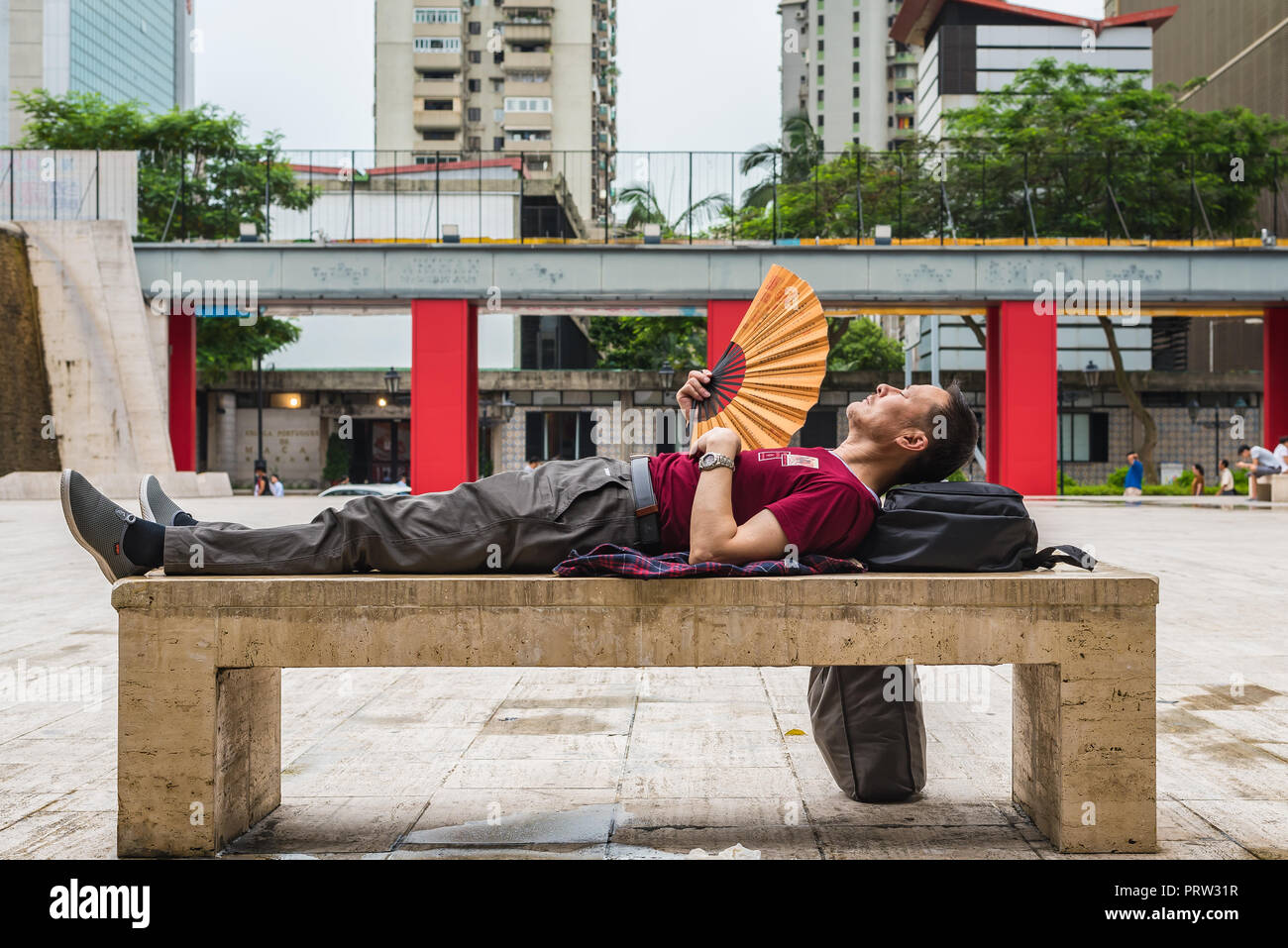 MACAU CITY, CHINA - AUG. 2, 2017 : A tourist is taking a nap at the ...