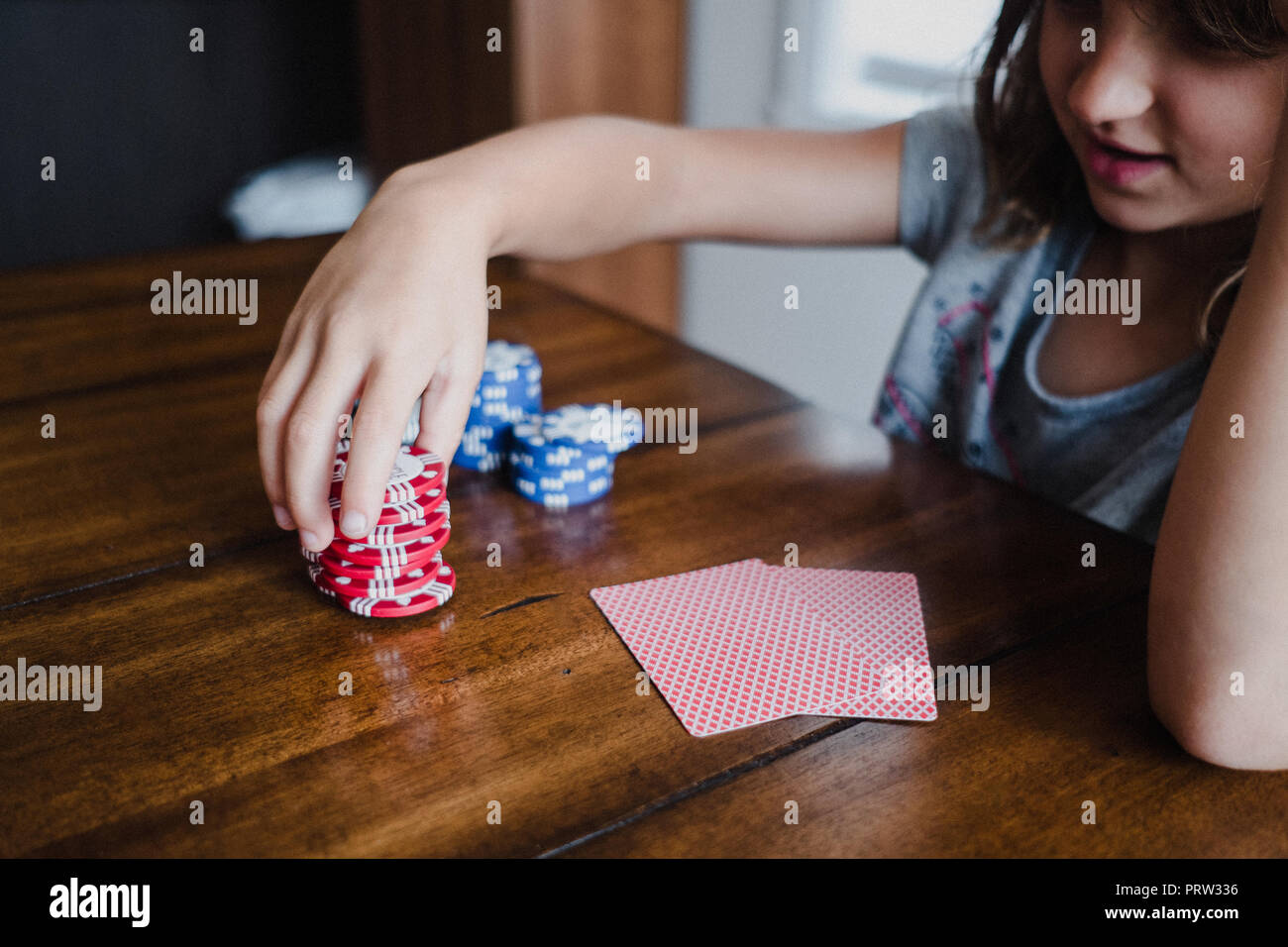 Girl playing cards at table, stacking gambling chips, close up Stock ...
