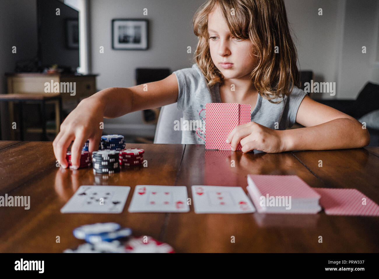 Girl playing cards hi-res stock photography and images - Alamy