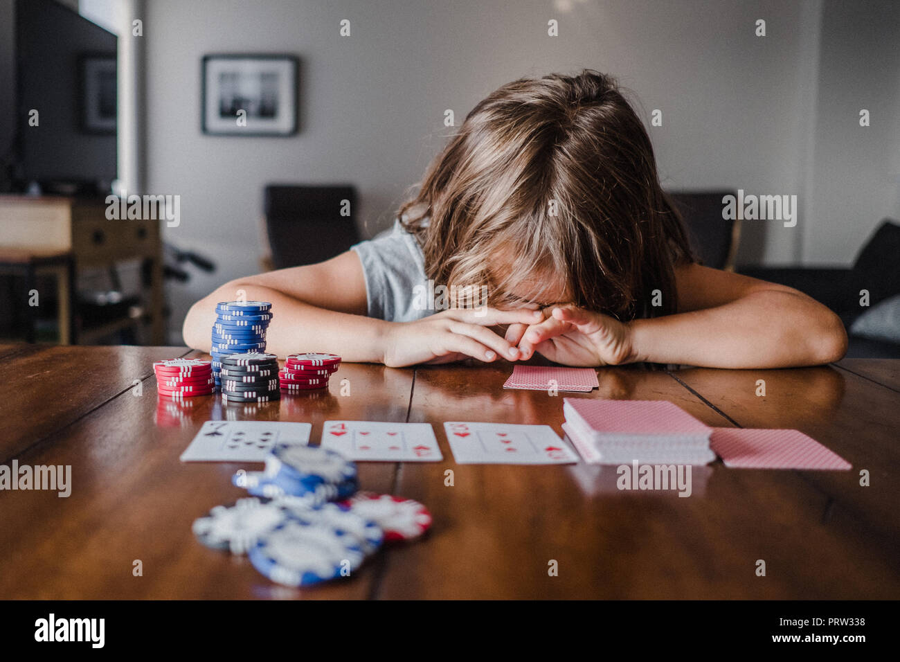 Girl playing cards hi-res stock photography and images - Alamy