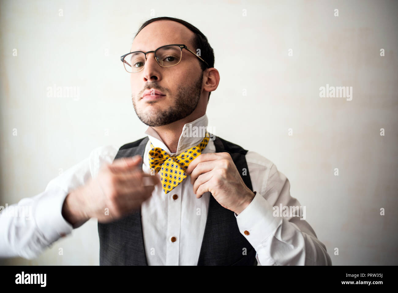 Businessman putting on bow tie hi-res stock photography and images - Alamy