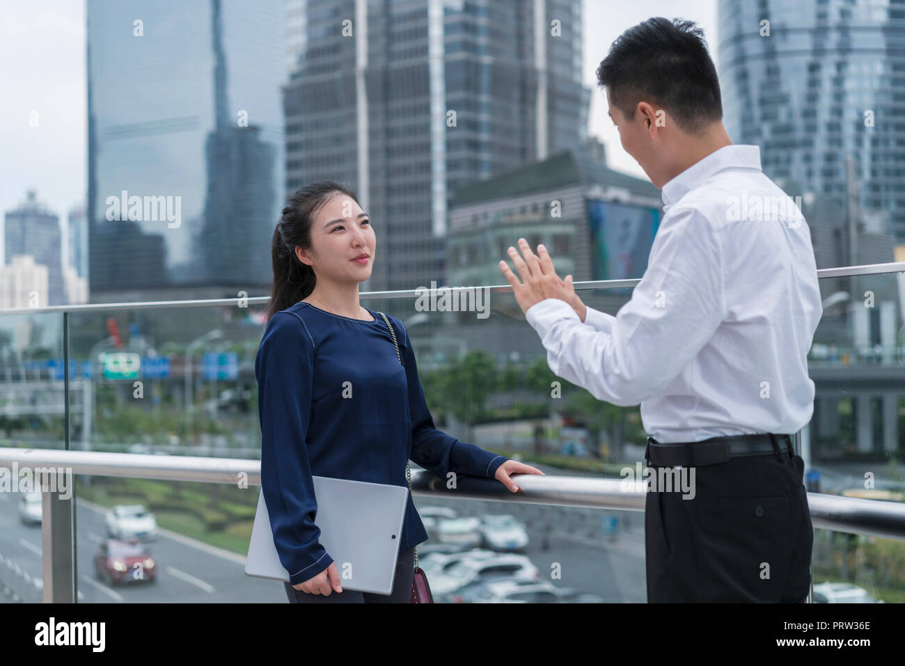 Two people talking on balcony hi-res stock photography and images - Alamy
