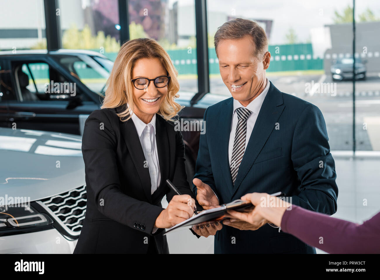 Signing papers at dealership hi-res stock photography and images - Alamy