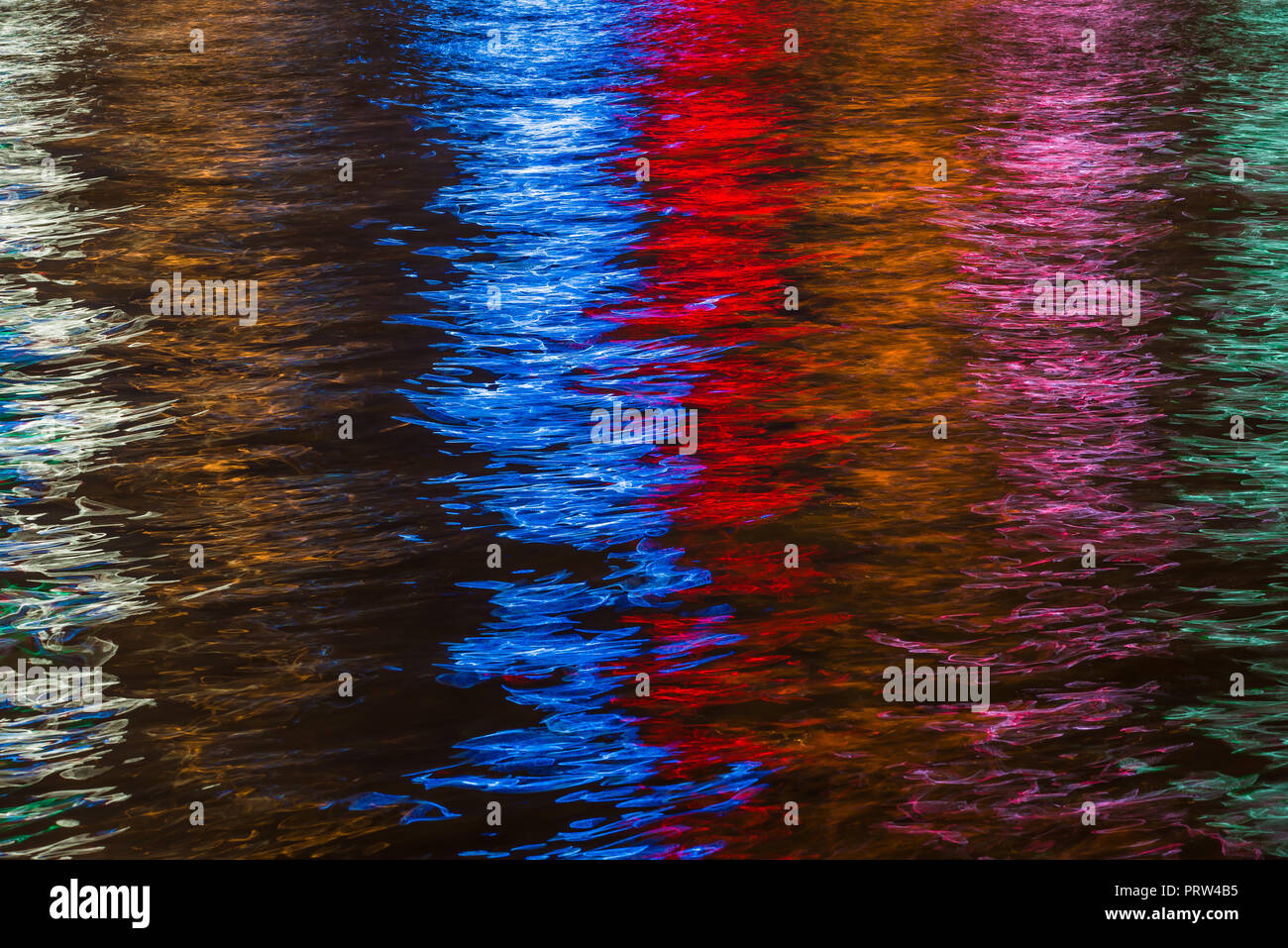 The reflection of the multicolor light on the water surface Stock Photo ...