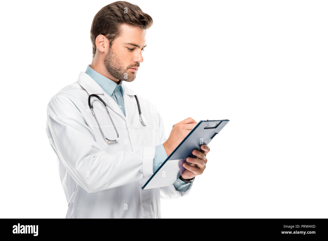 side view of male doctor with stethoscope over neck writing in ...