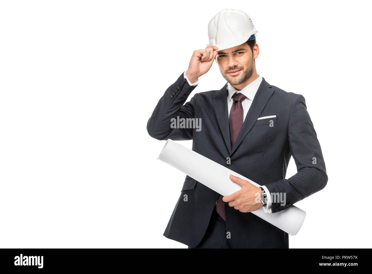 happy young male architect in suit holding blueprints and adjusting ...