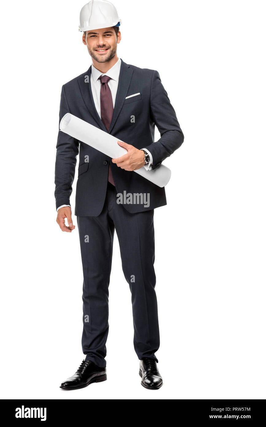 cheerful young male architect in hard hat and jacket holding blueprints ...