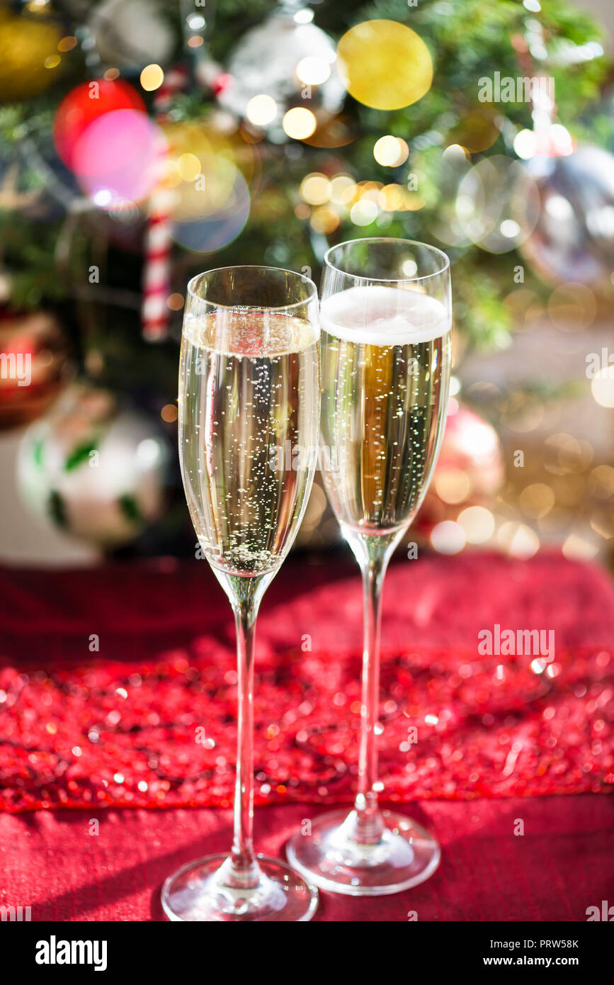 Two Champagne Flutes on Christmas Background with Xmas Tree Stock Photo ...