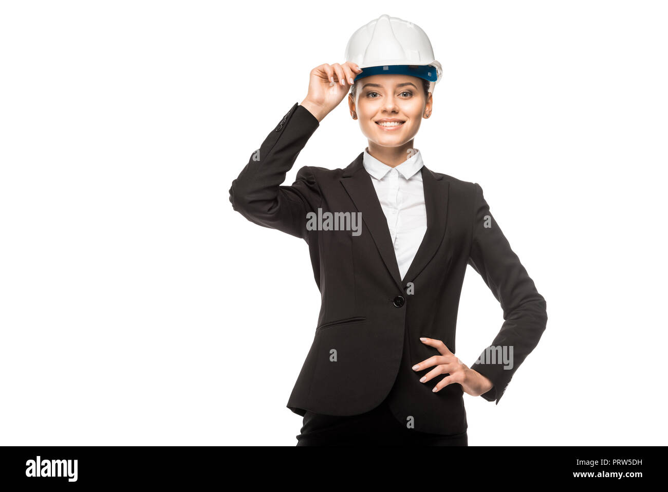 happy young female architect in helmet and suit looking at camera ...