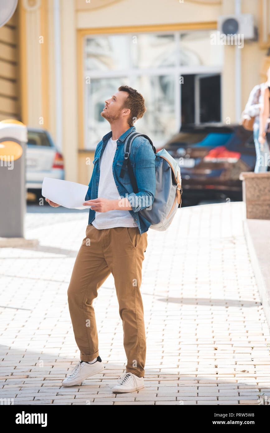 Man walking backpack map hi-res stock photography and images - Alamy