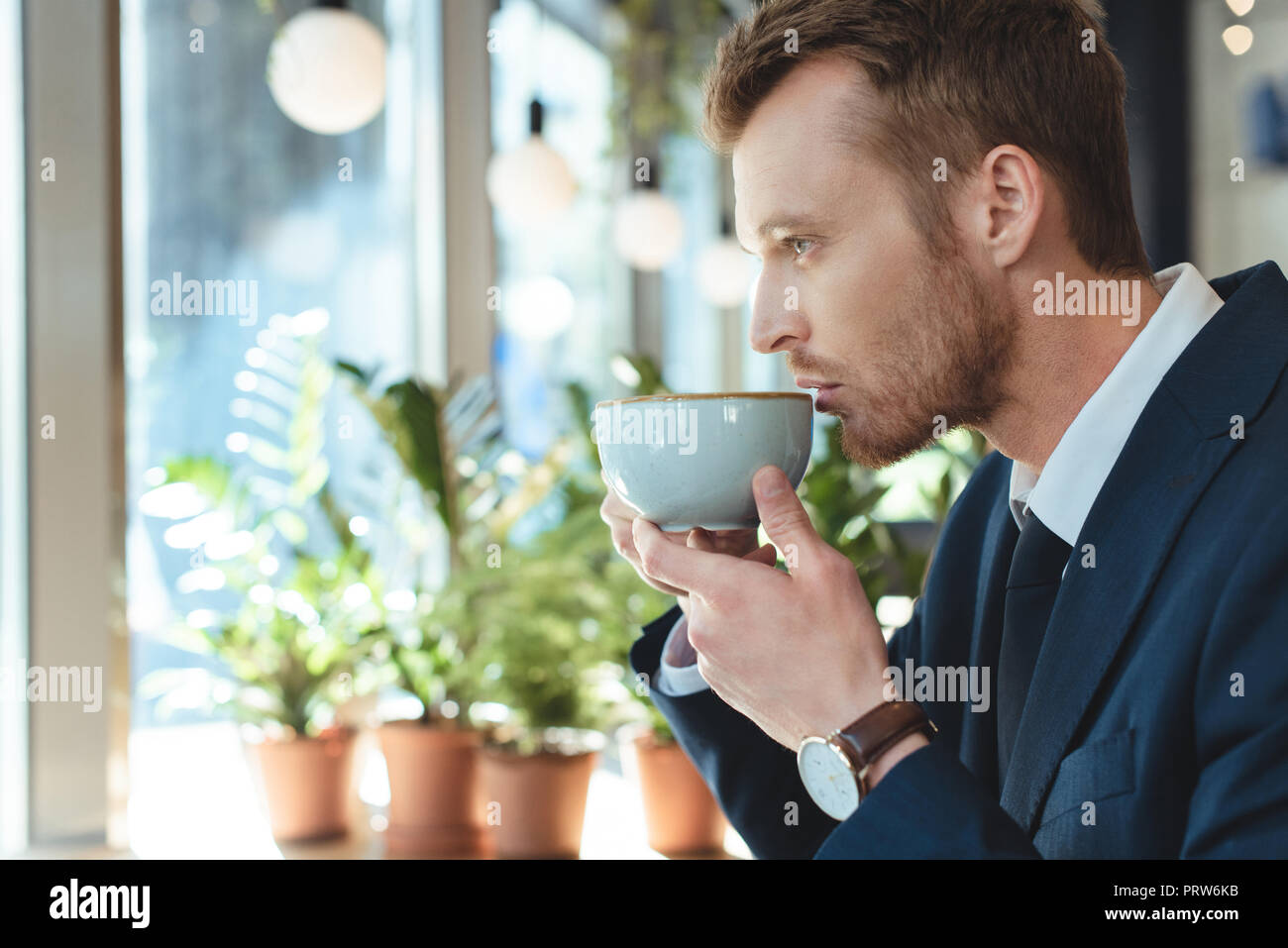side view of stylish businessman having coffee break in cafe Stock ...
