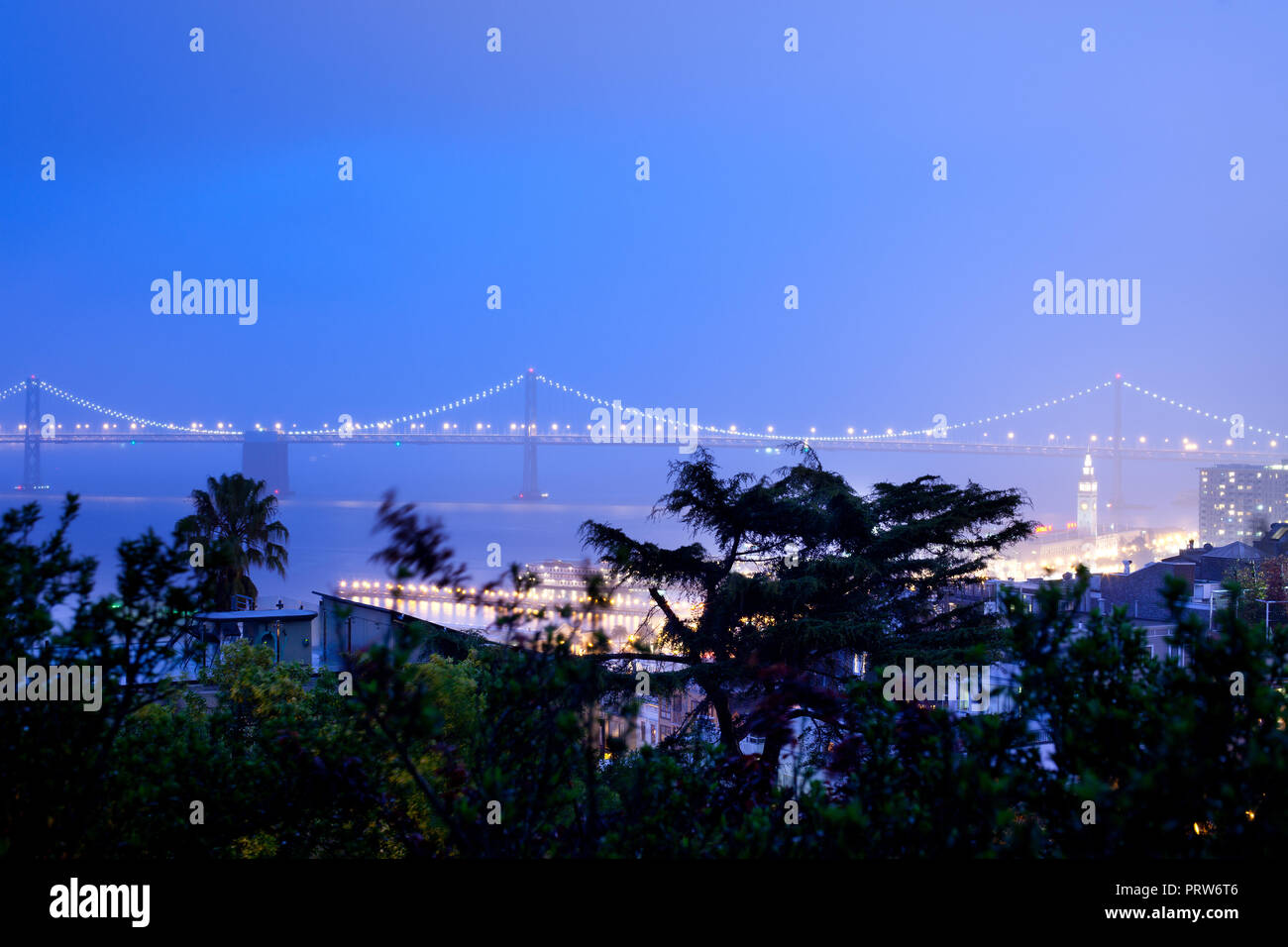 San francisco-oakland bay bridge and Port of San Francisco at night ...