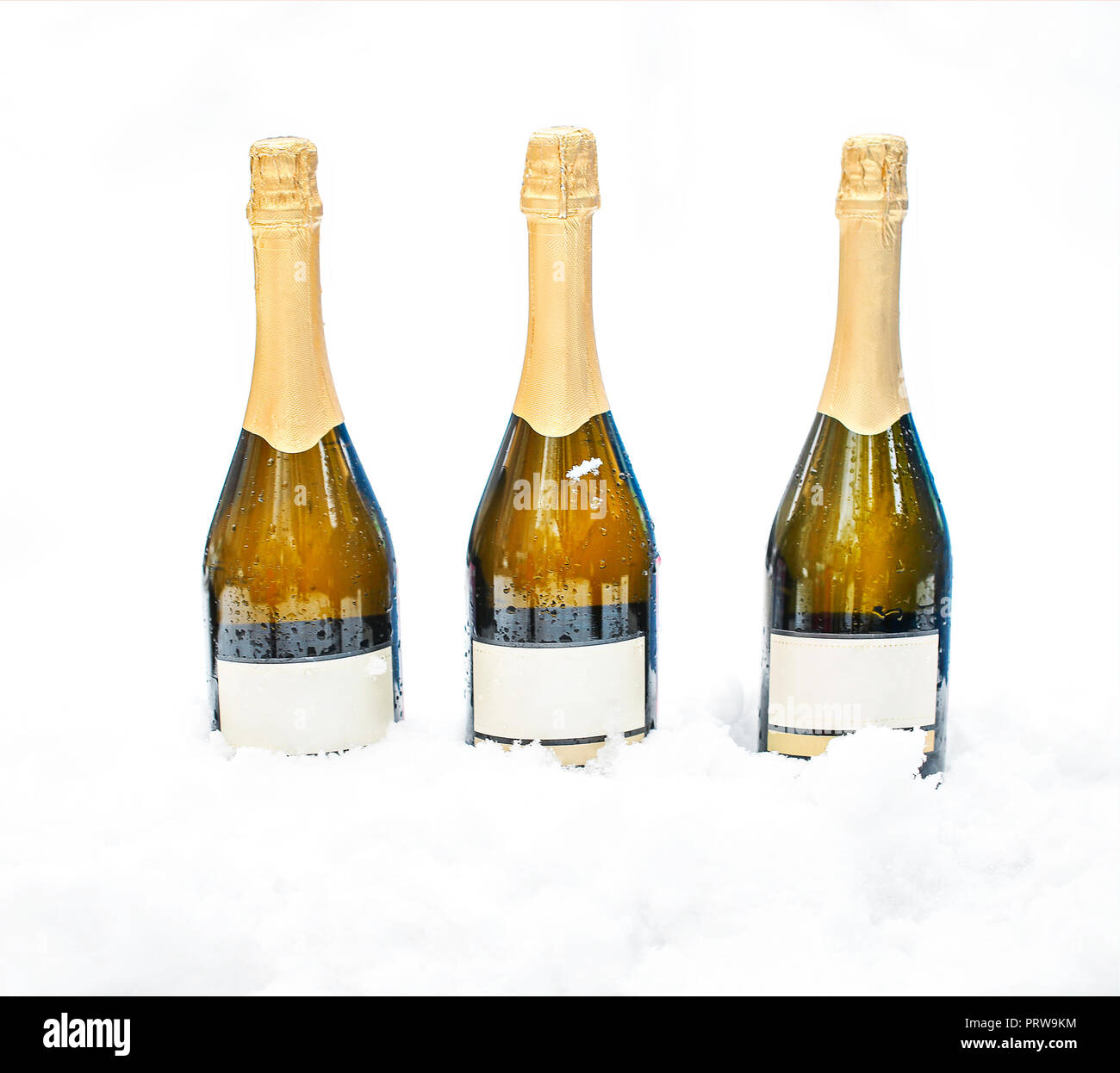 Three bottles of champagne in the snow. Winter holiday background Stock ...