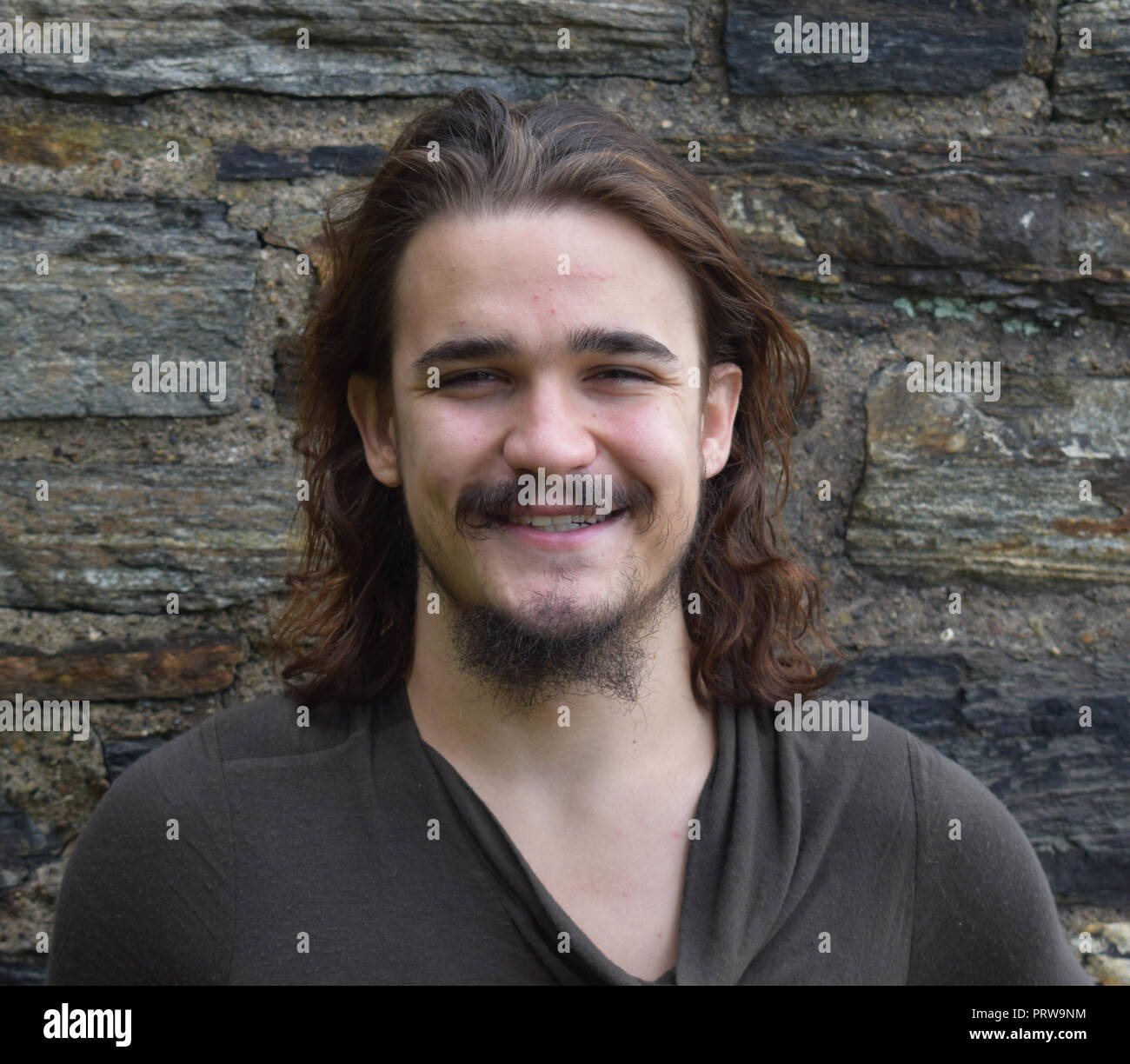 Young Caucasian male with long brown hair, mustache and beard posing ...