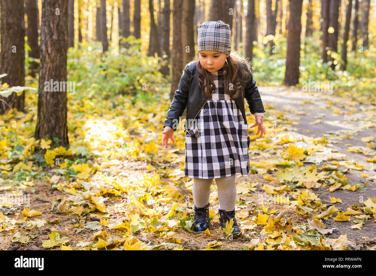 Fall, childhood and season concept - Little girl playing in the autumn ...