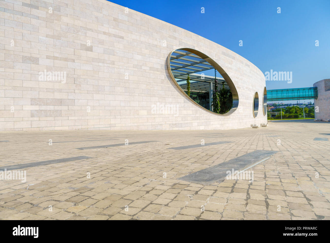 Oval stone oppening detail looking into internal shaded courtyard of ...