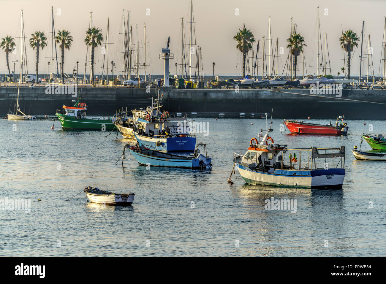 Small fishing boats floating in the fish port of Cascais - Portugal ...
