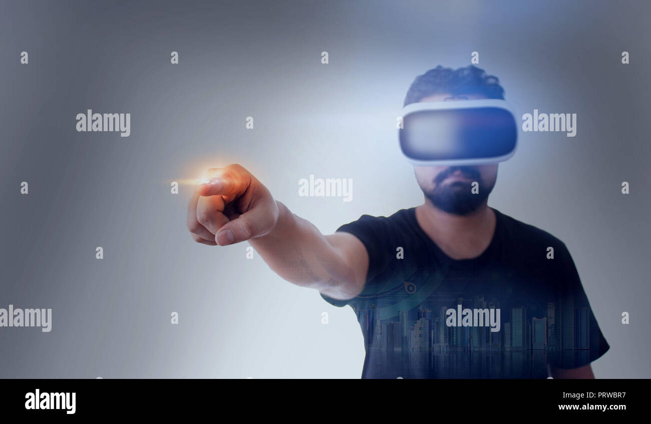 Young Guy in black t shirt looking through VR (Virtual Reality) glasses ...