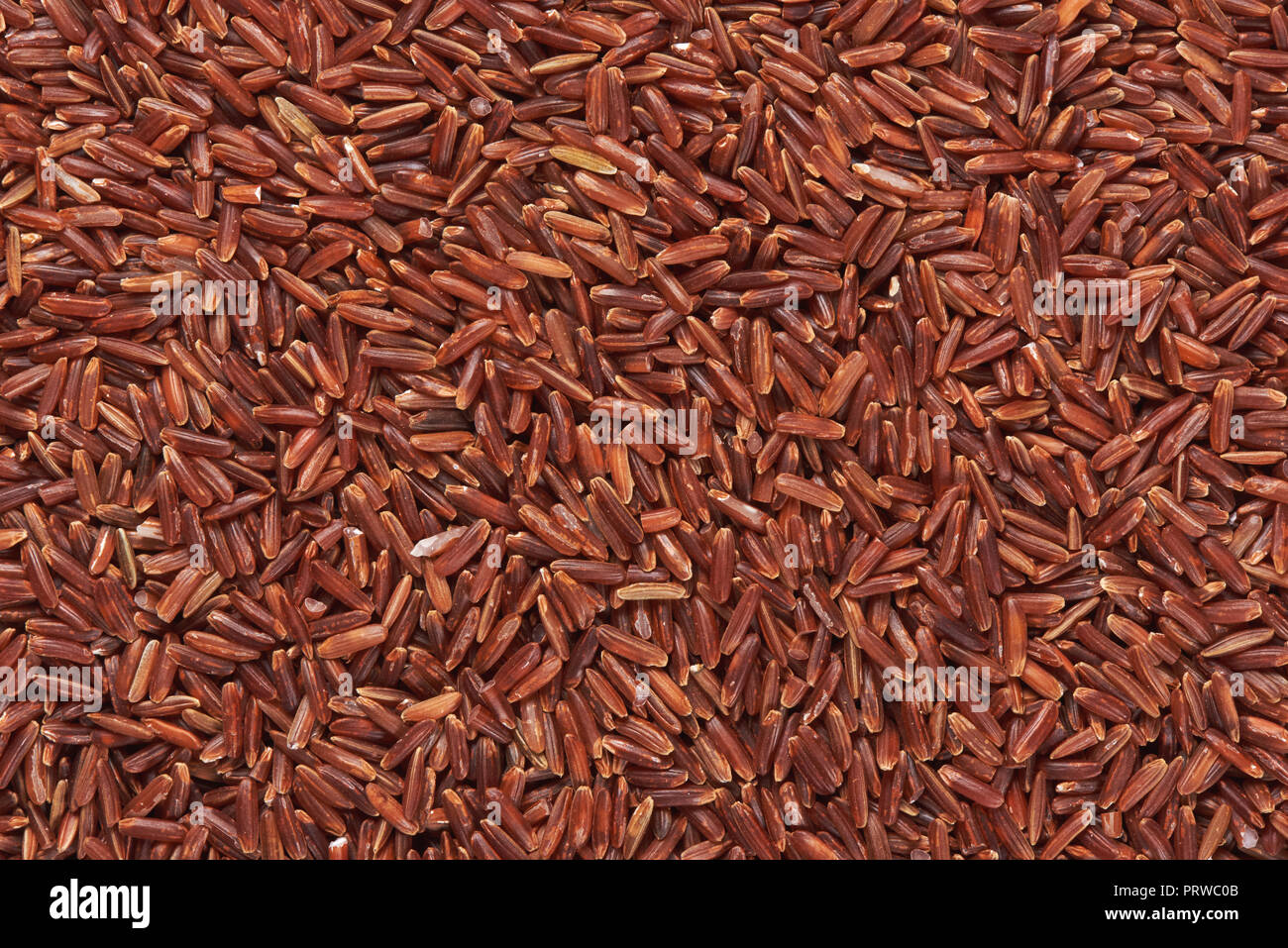 Dry red rice background. Uncooked food texture Stock Photo - Alamy