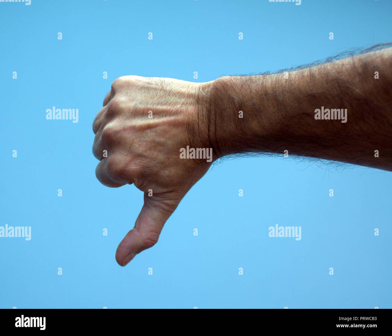 Thumbs down sign made by mans hand Stock Photo - Alamy