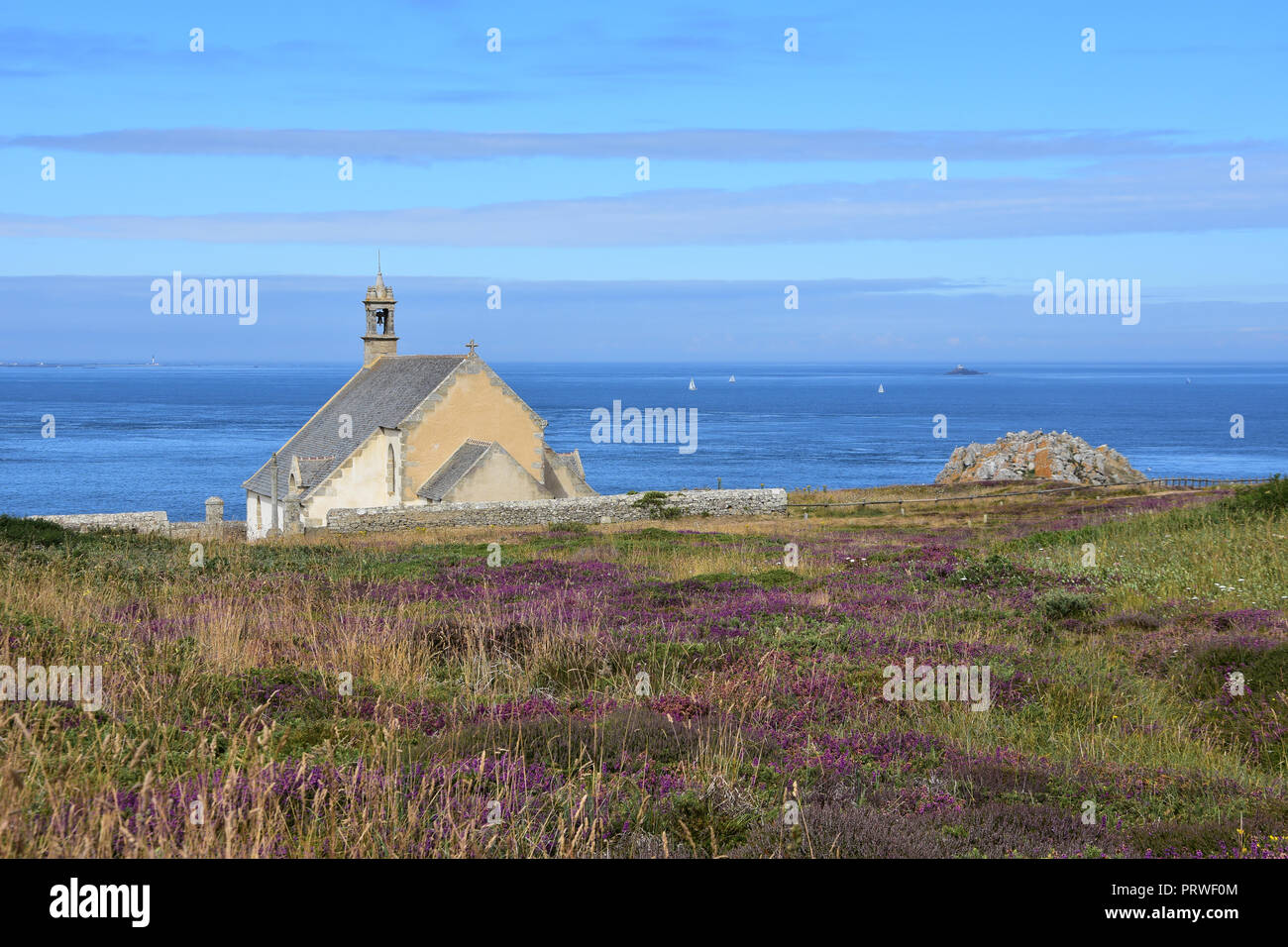 French countryside, green field with wild herbs. The old stone-built ...