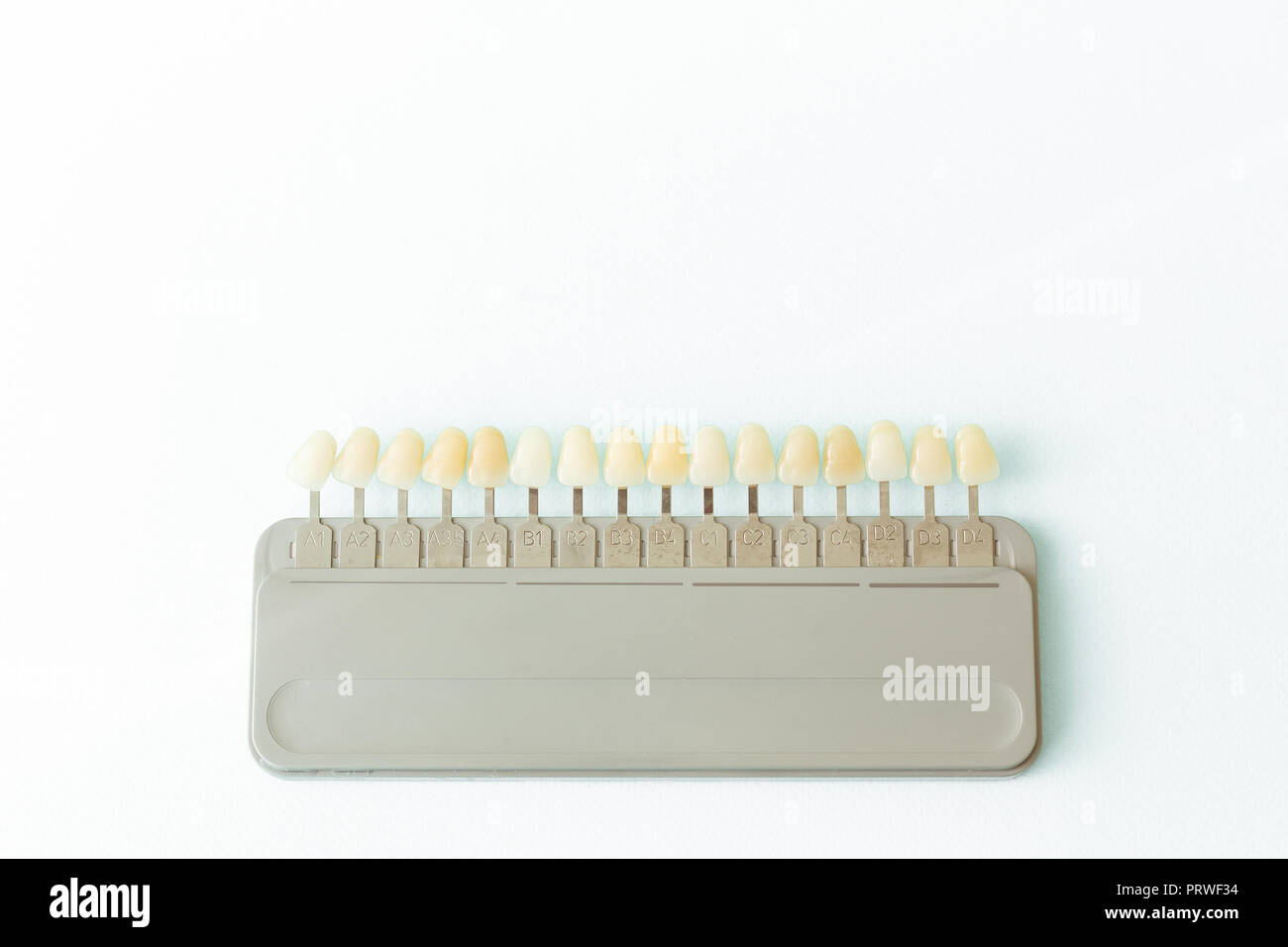 Plastic dental implant for choose color tone of teeth isolated on white ...