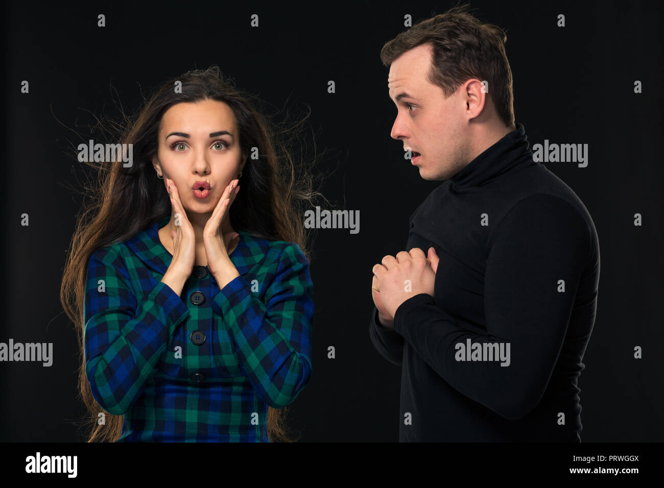 Excited scared nervous woman look into camera, man stand by side, have ...