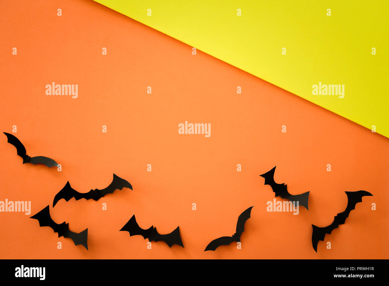 Flying black paper bats on orange background. Halloween. Text space ...