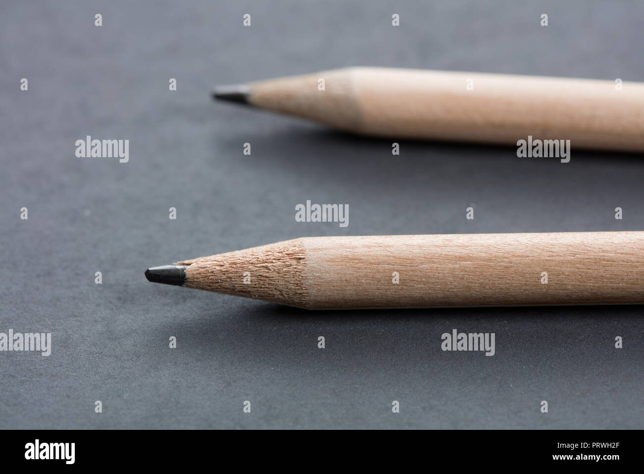close-up view of two pencils on dark-grey background Stock Photo - Alamy