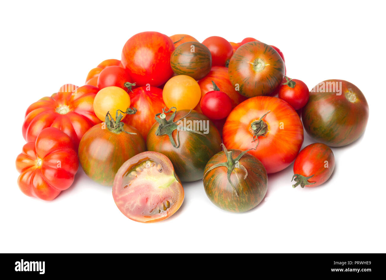 heap of various ripe tomatoes isolated on white background Stock Photo ...