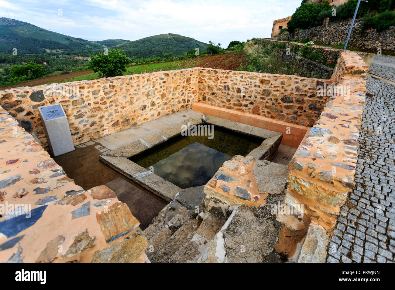 View of an open air medieval communal laundry facility after repair and ...